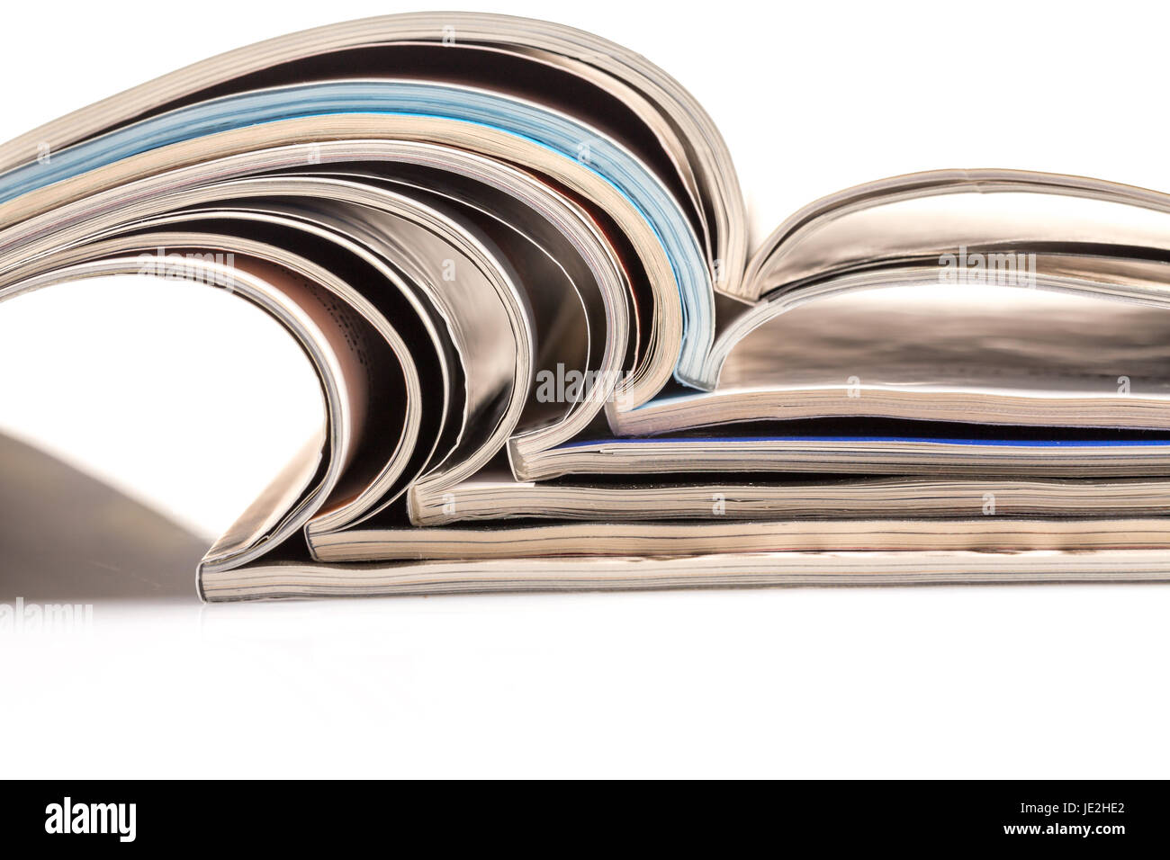 Stack of magazines on white background with reflection Stock Photo - Alamy