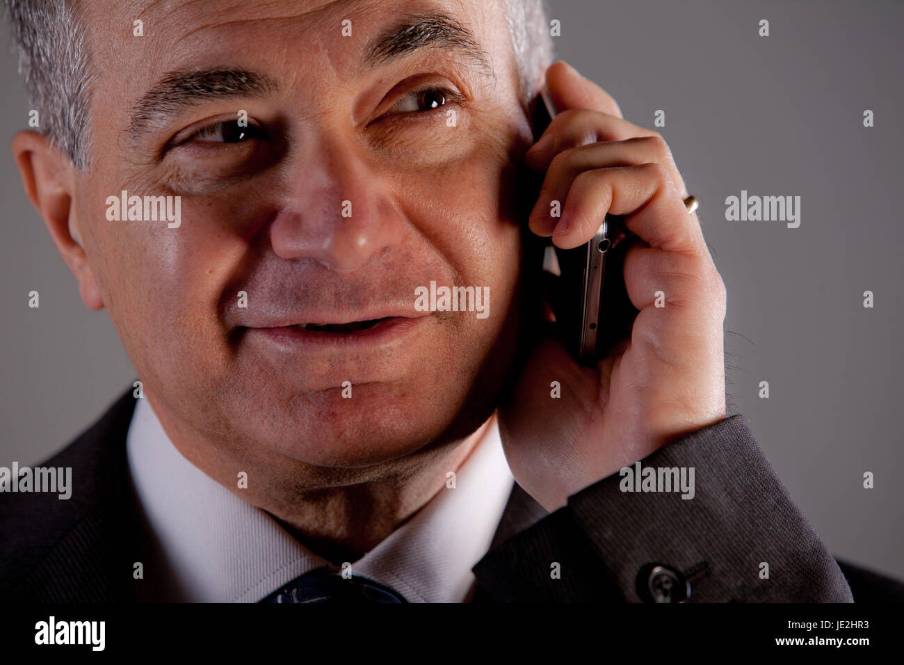 A senior manager using successfully his inseparable smartphone agenda ...