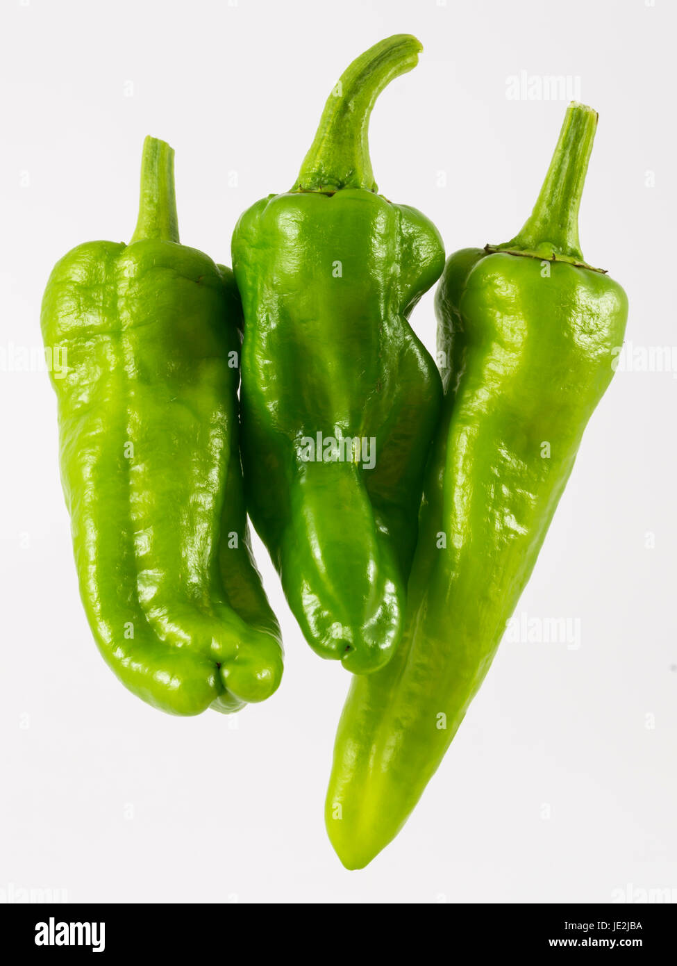 three green pepper on white background Stock Photo - Alamy