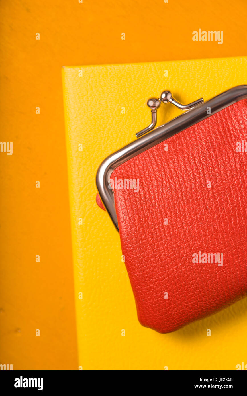 Orange purse on the bright yellow background top view vertical Stock ...