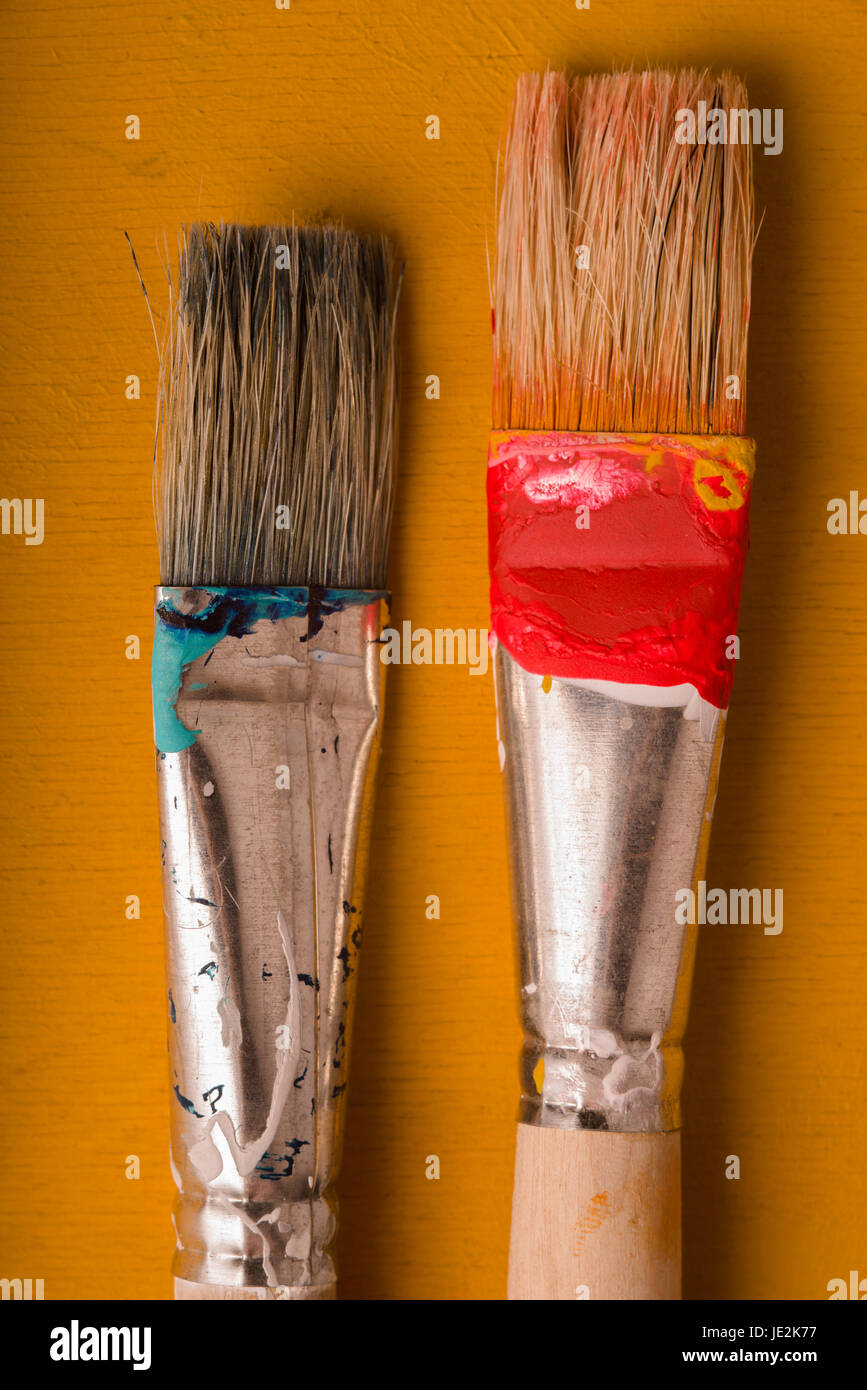 Paint brushes on the yellow background top view vertical Stock Photo ...