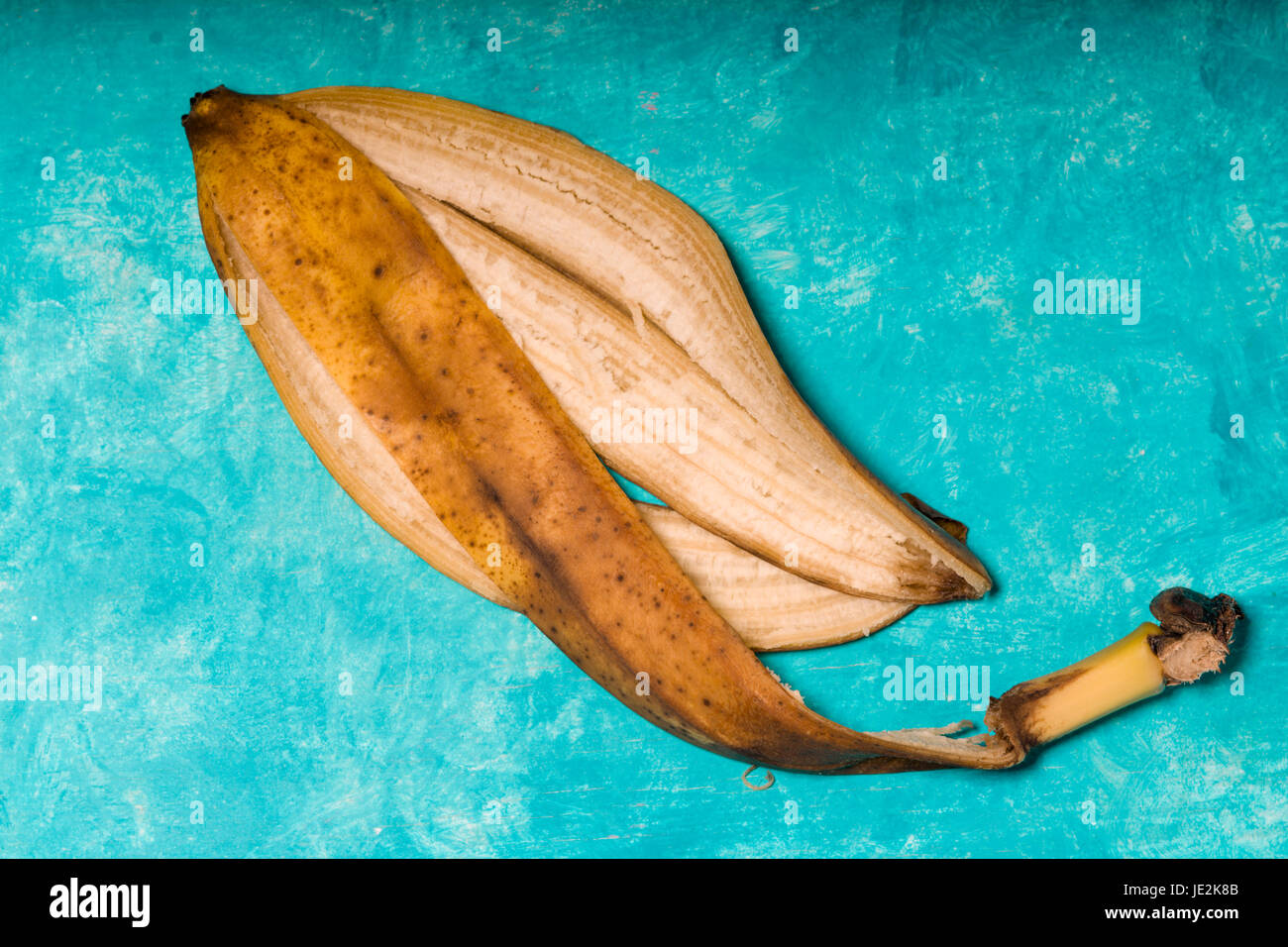 Banana peel on the cyan background top view horizontal Stock Photo - Alamy