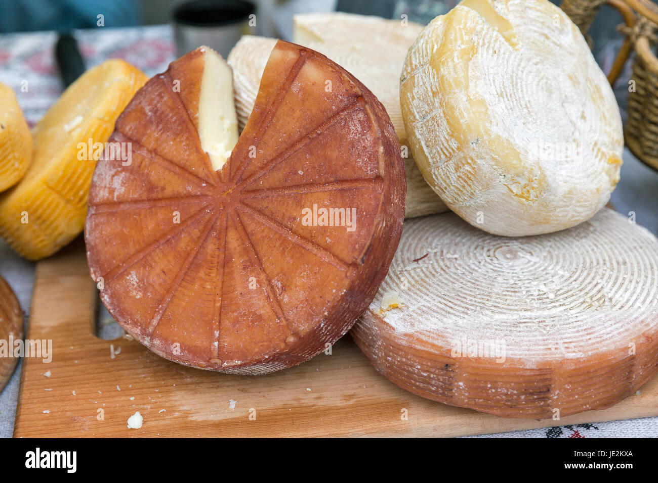 Different cheese in packs and in bulk on market counter Stock Photo - Alamy