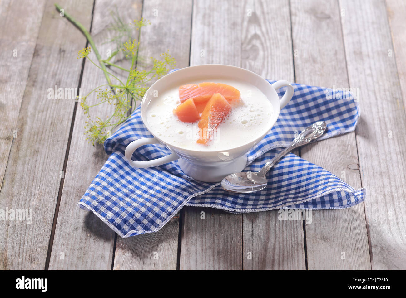 Stylish white ceramic bowl of fresh salmon chowder with fennel and raw ...