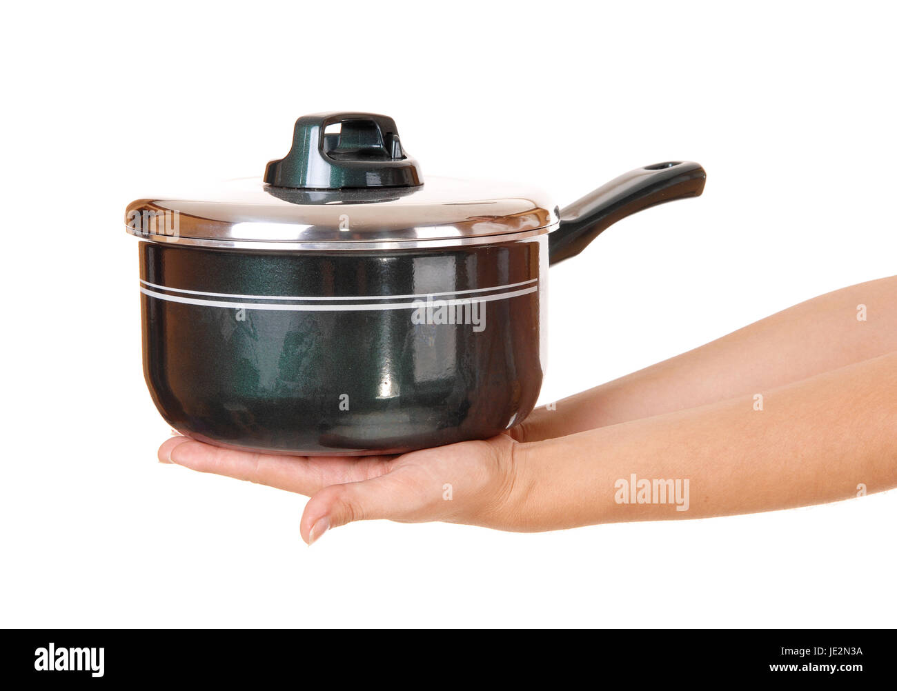 The hands of a woman holding a green cooking pot, isolated for white ...