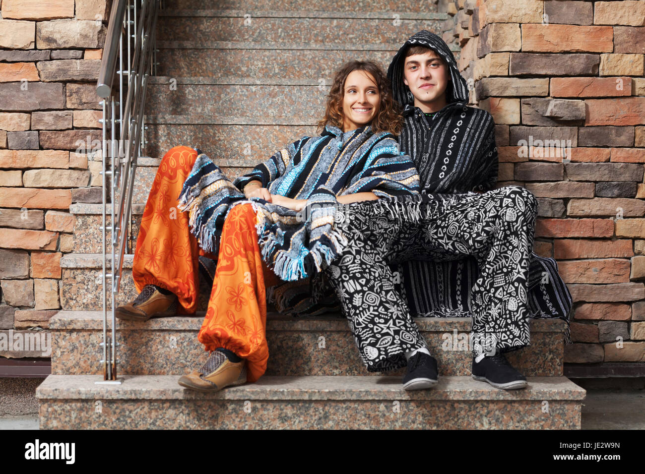 Young hippie couple sitting on the steps Stock Photo - Alamy