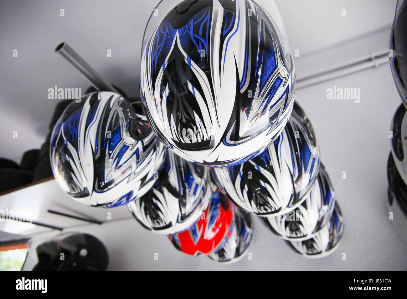 Go-Kart helmets hanging assorted. Karting circuit workshop Stock Photo ...