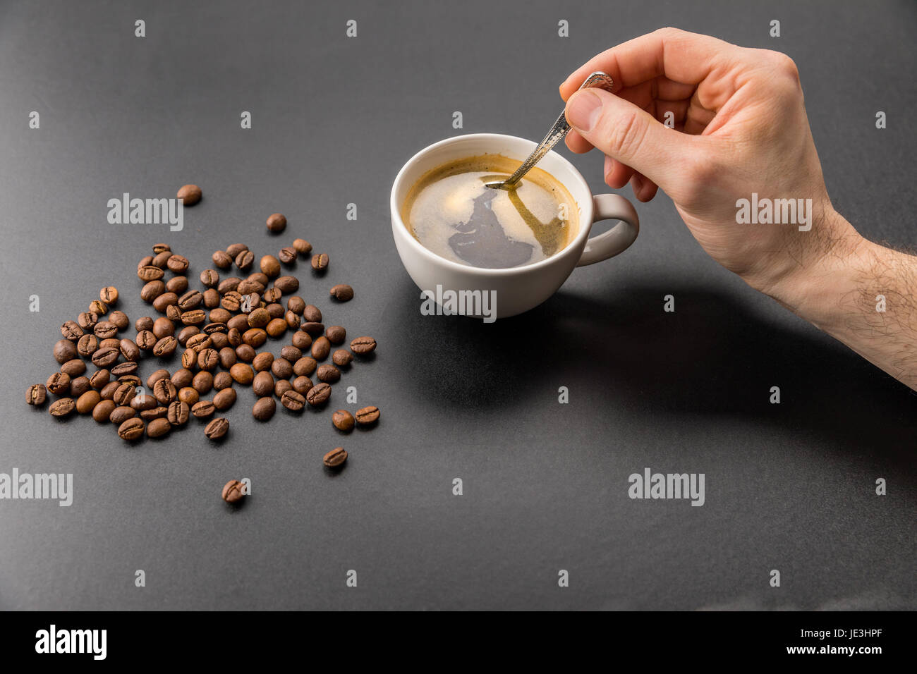 Close-up partial view of person mixing hot coffee with spoon Stock ...