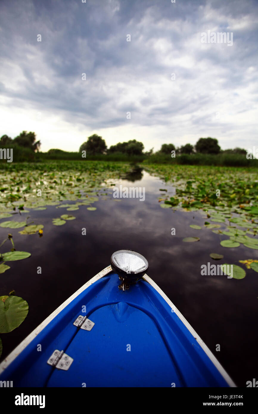 Color picture of a boat on a river bank Stock Photo - Alamy