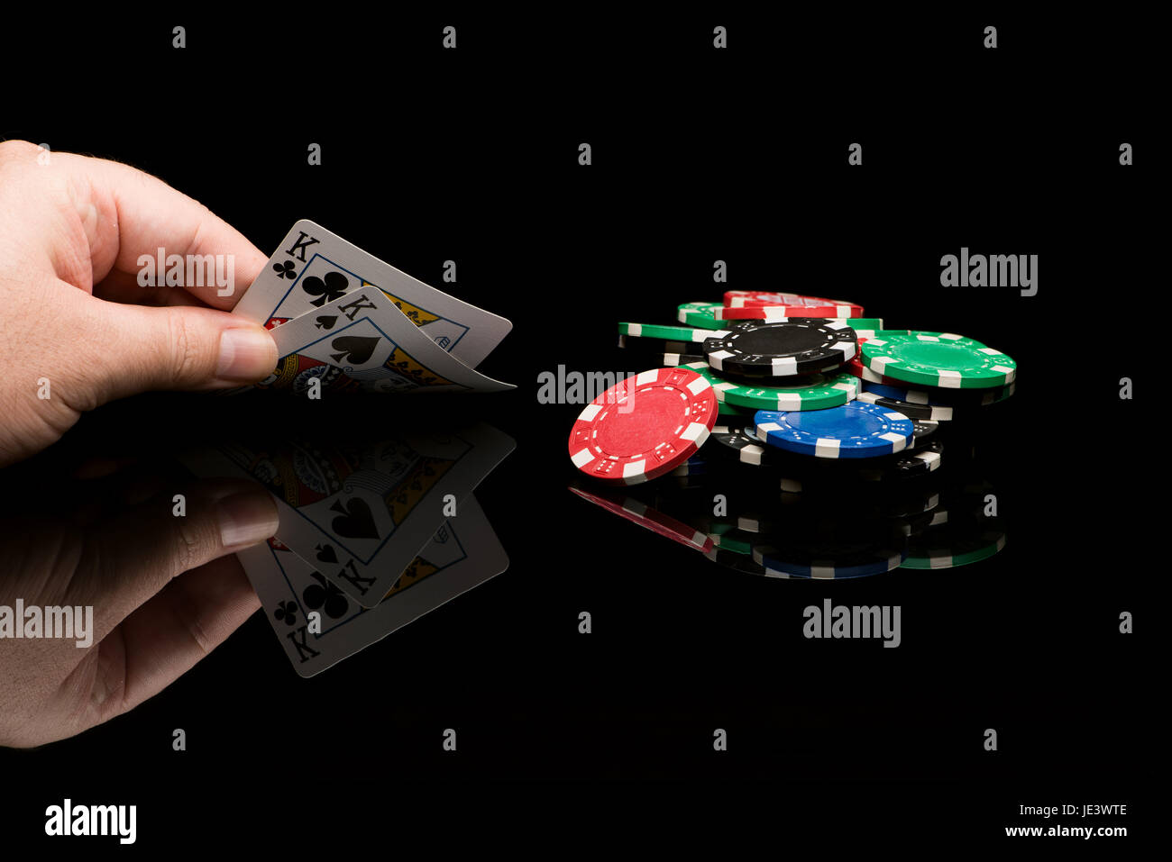 Poker cards with hand on black background with reflexion Stock Photo ...