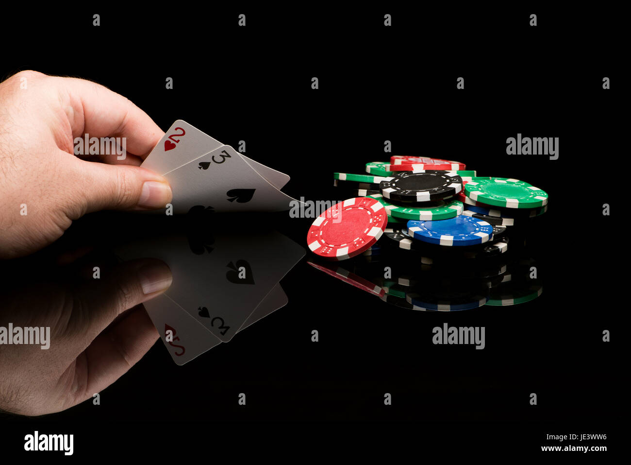 Poker cards with hand on black background with reflexion Stock Photo ...
