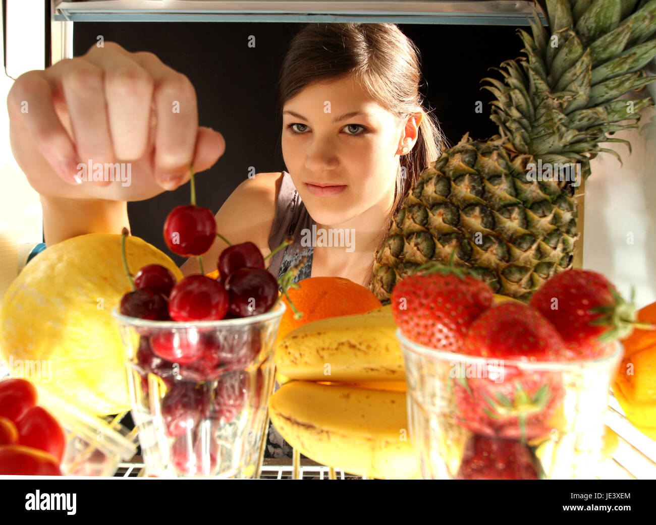girl reaching into the fridge Stock Photo - Alamy