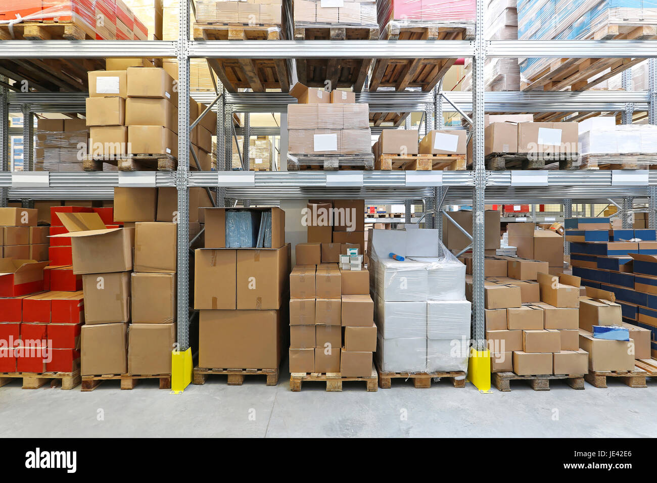 Boxes with goods at shelves in warehouse Stock Photo - Alamy