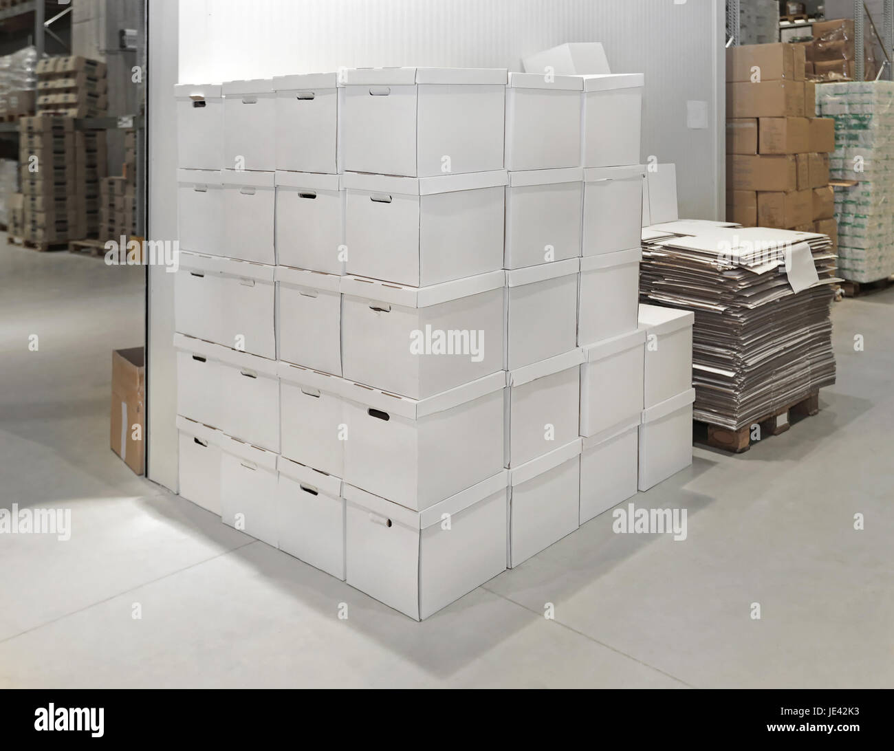 White transport boxes in distribution warehouse Stock Photo - Alamy