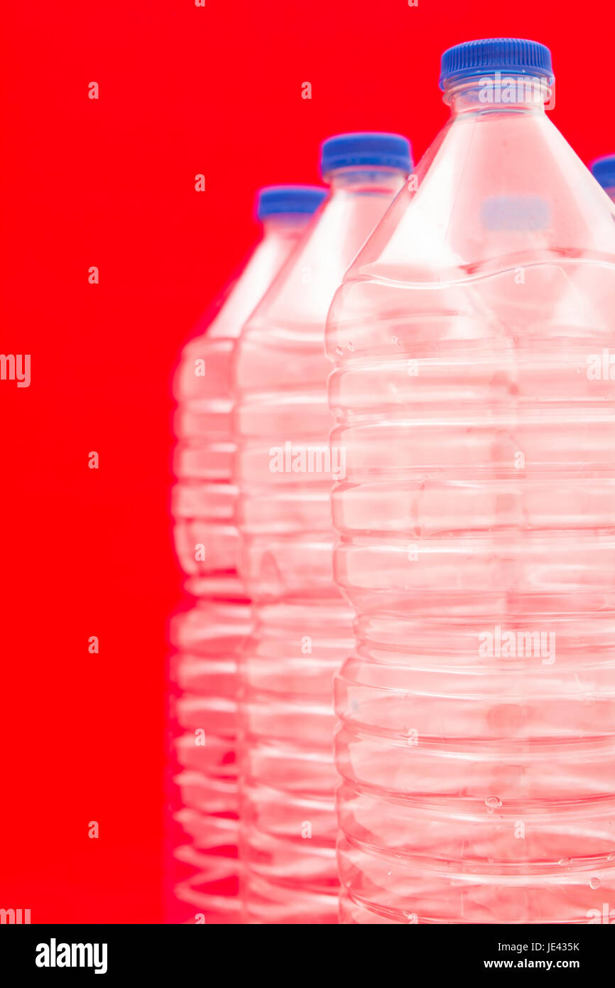Empty bottles of mineral water with red background Stock Photo - Alamy