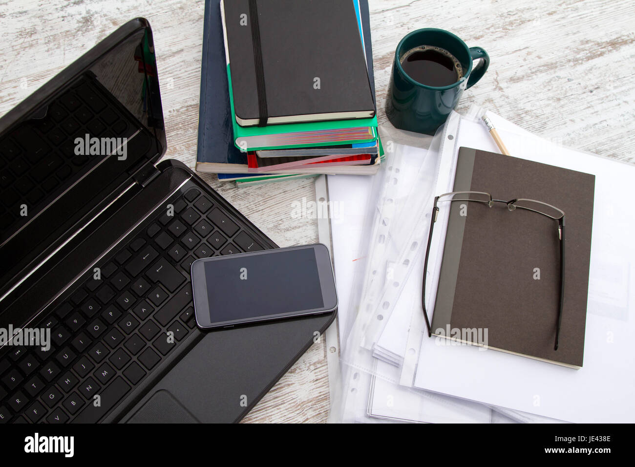 Working, with the laptop, a pile of books, and drinking a coffee Stock ...