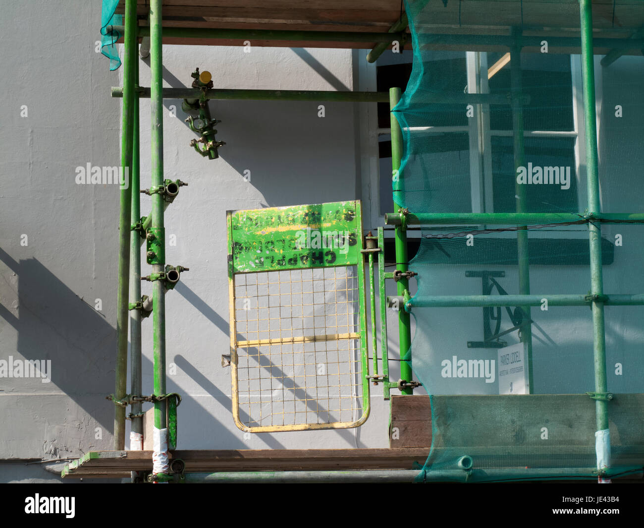 Scaffolding access gate to residential building undergoing renovation ...