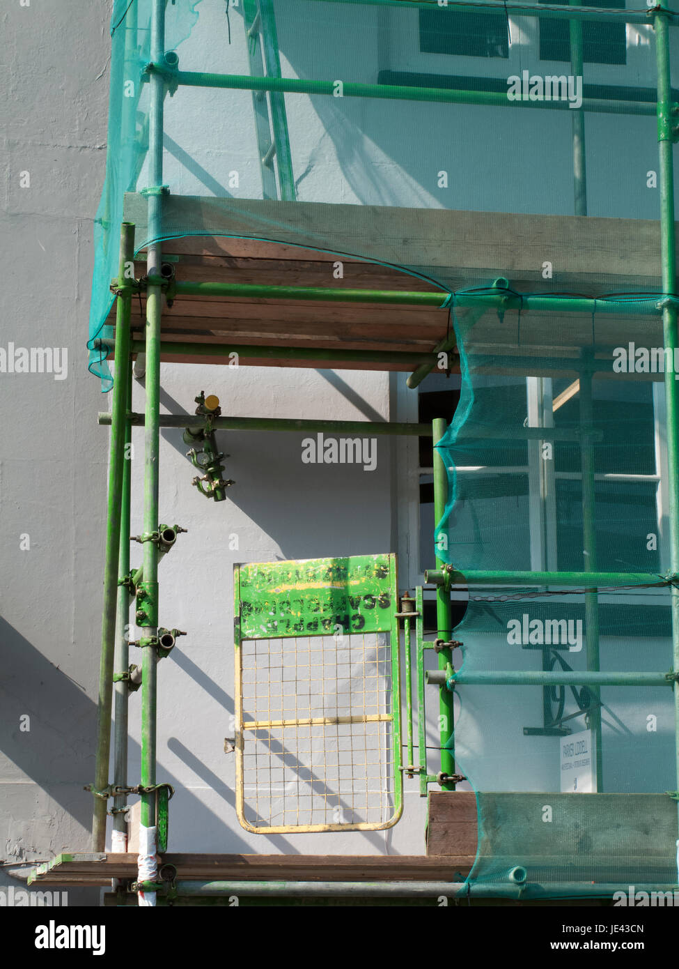 Scaffolding access gate to residential building undergoing renovation ...