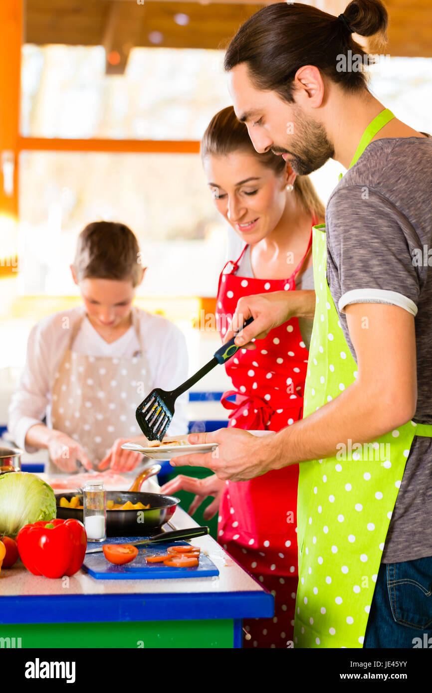Family with Parents and children preparing healthy meal in domestic ...