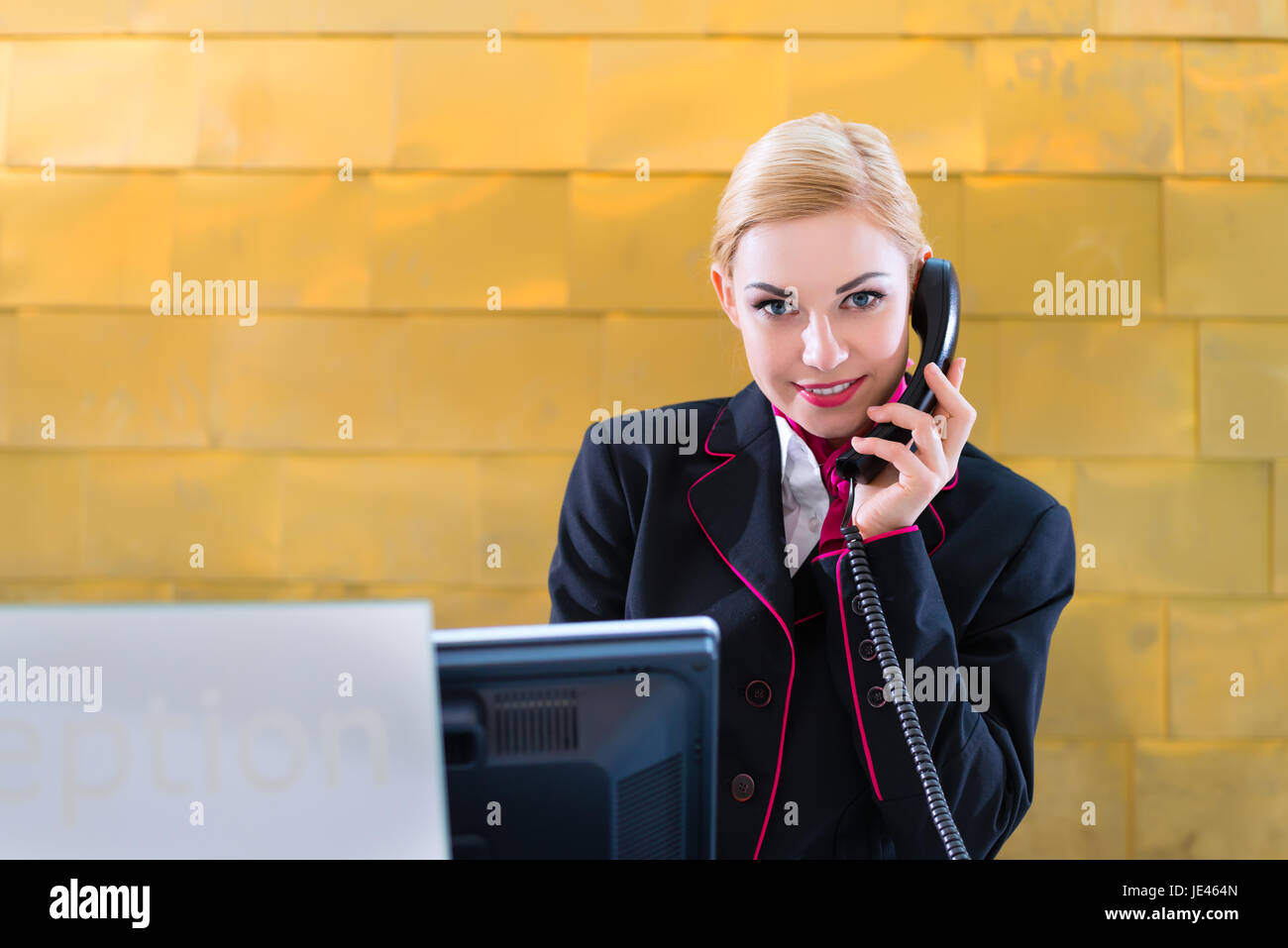 Female hotel receptionist talking on telephone hi-res stock photography ...