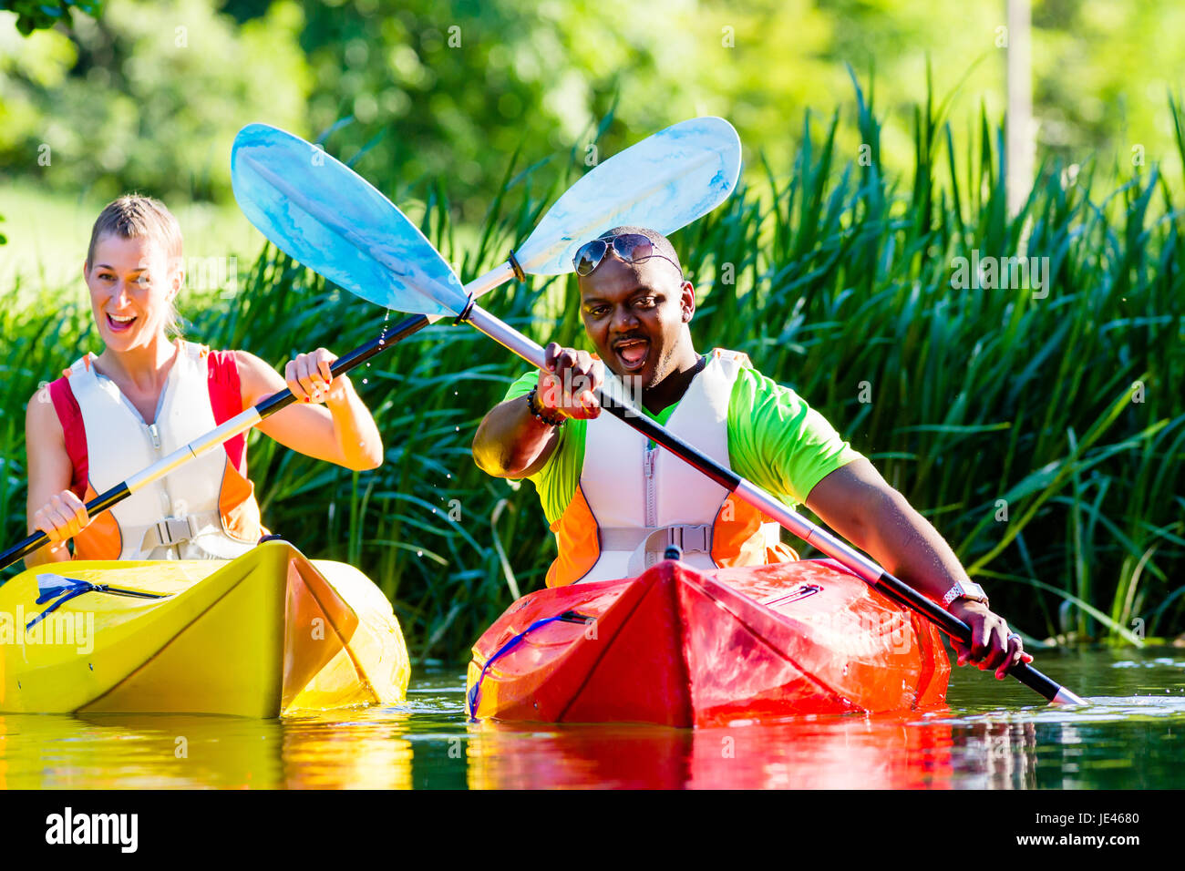 Friends driving with kayak on forest river Stock Photo - Alamy