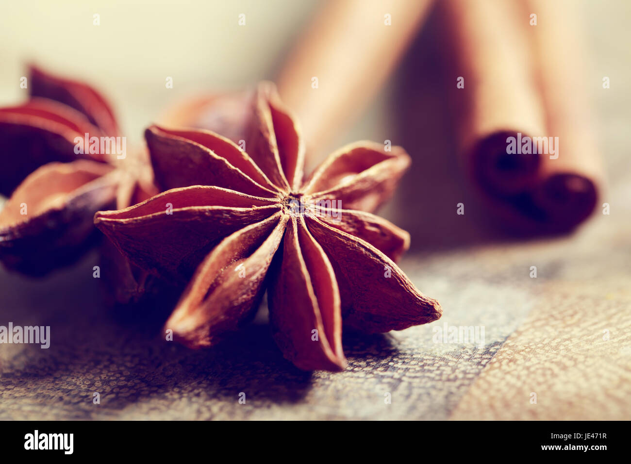 Star anise with cinnamon sticks on rustic wooden table Stock Photo - Alamy