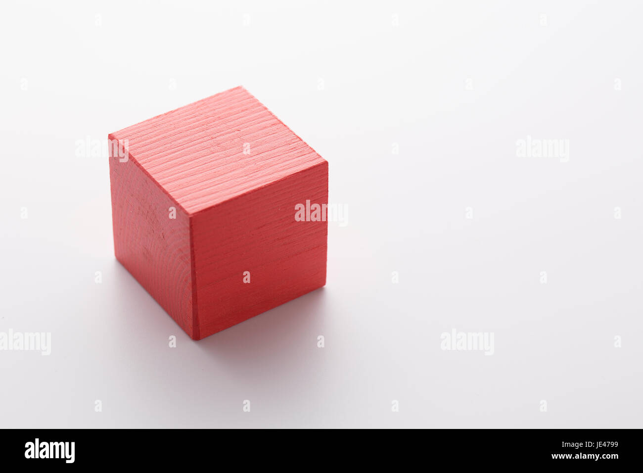Red wooden cube isolated on white background Stock Photo - Alamy