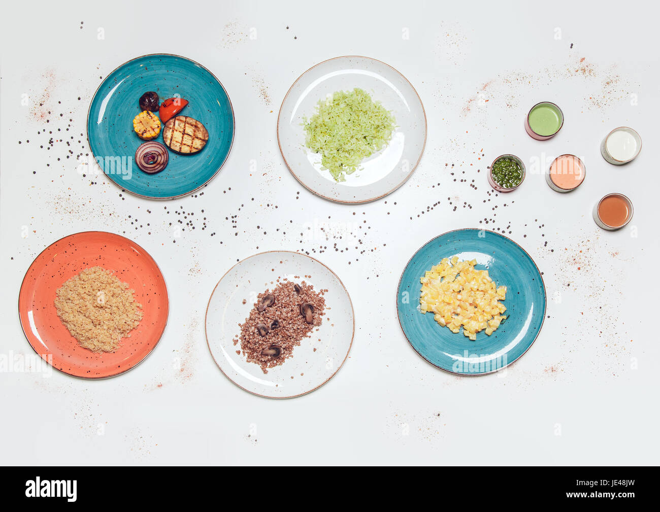 Plates with garnishes on a white table. view from above Stock Photo - Alamy