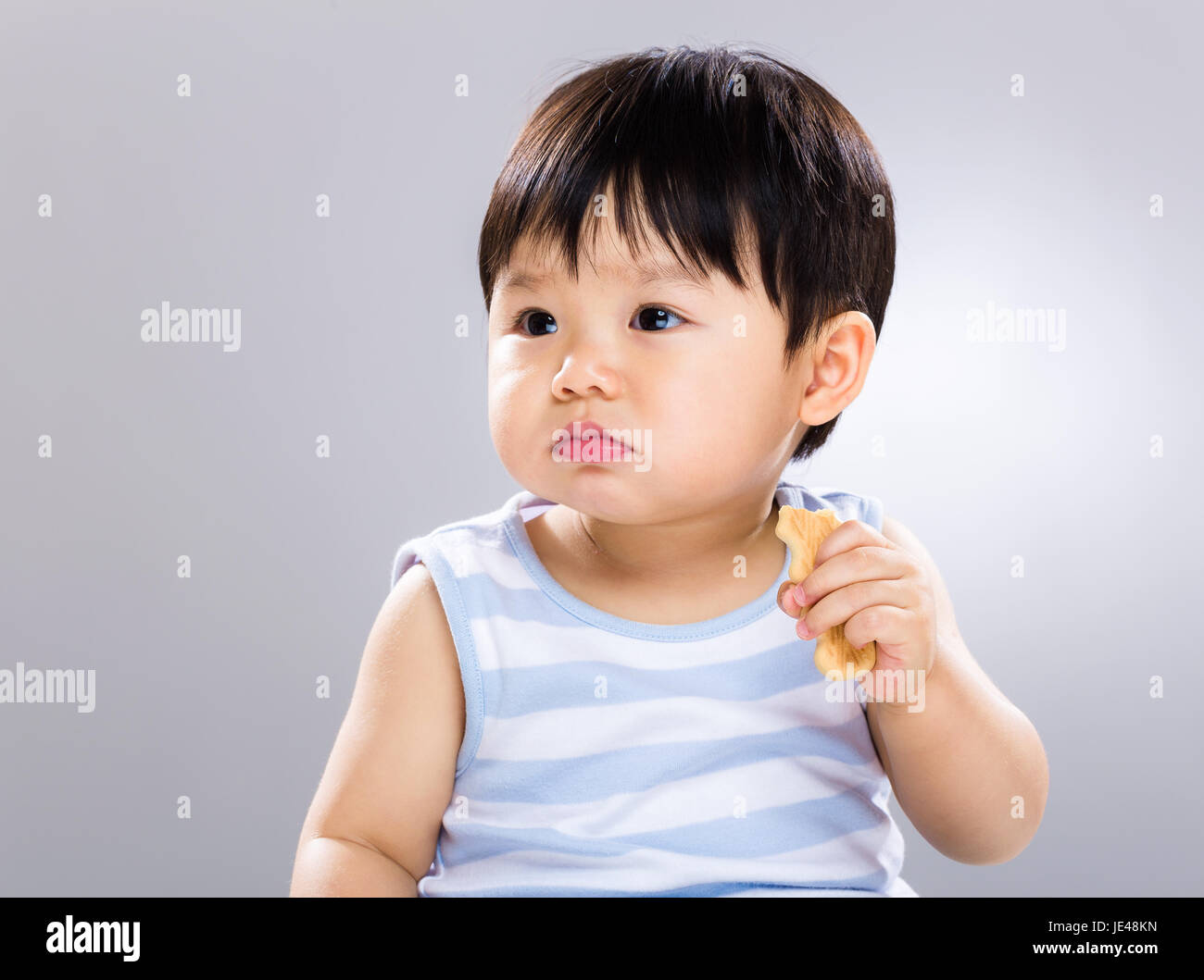 Baby eat biscuit Stock Photo - Alamy
