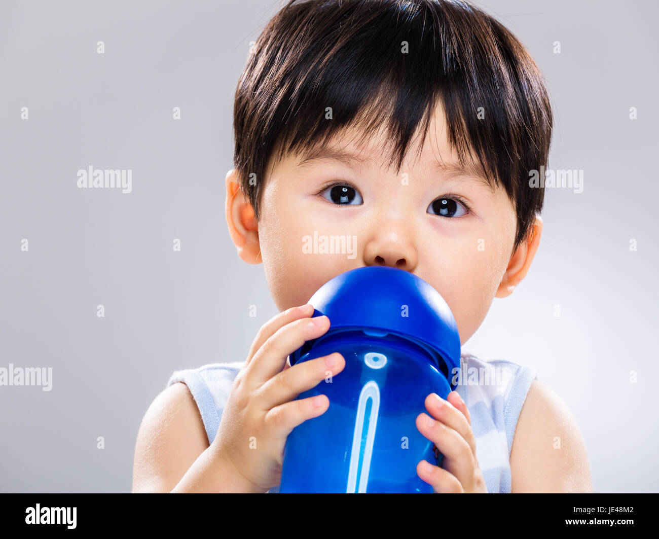 Little baby drink water form bottle Stock Photo - Alamy