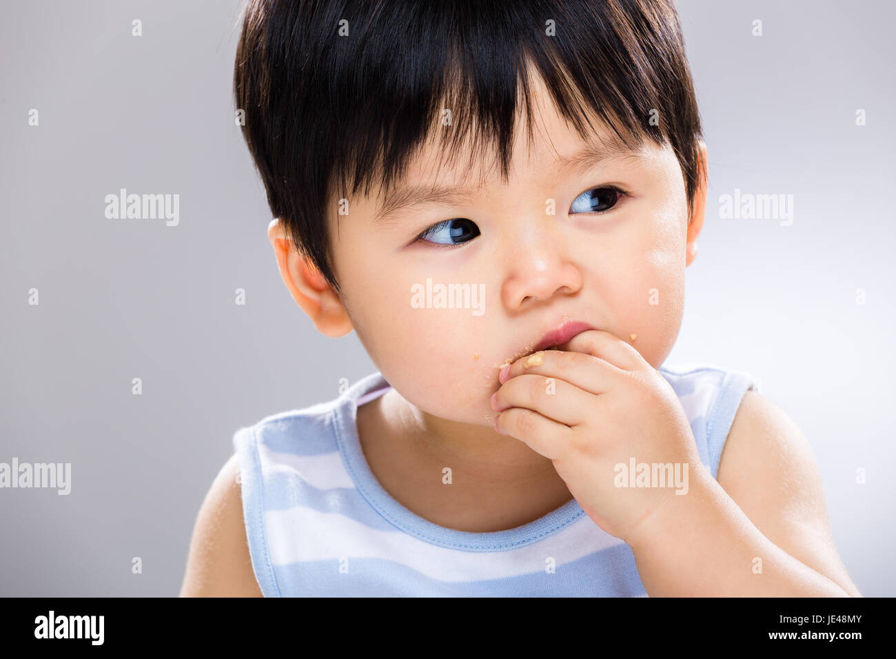 Asian baby boy eat biscuit Stock Photo - Alamy