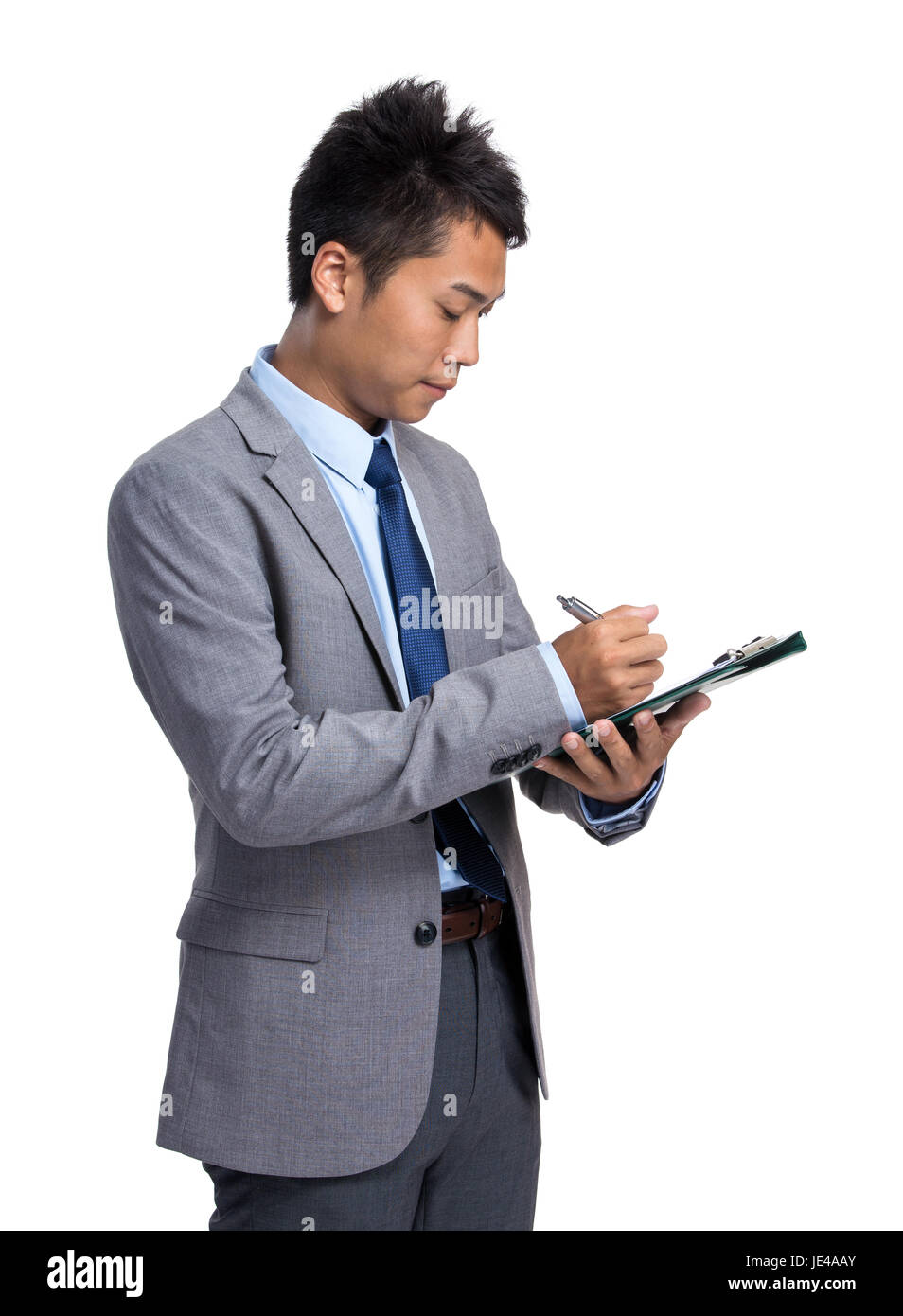 Asian business man write on clipboard Stock Photo - Alamy