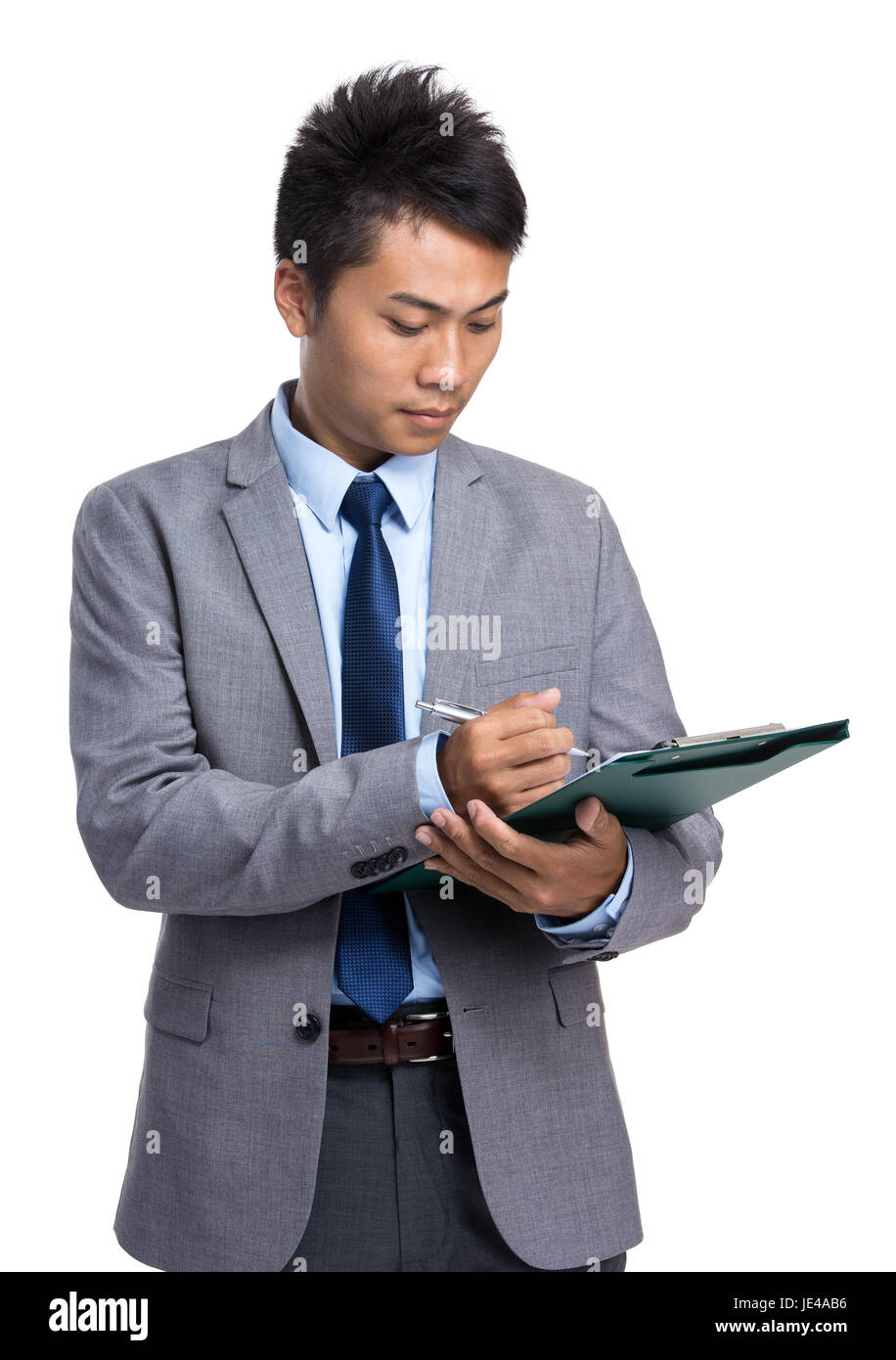 Asian businessman write on clipboard Stock Photo - Alamy