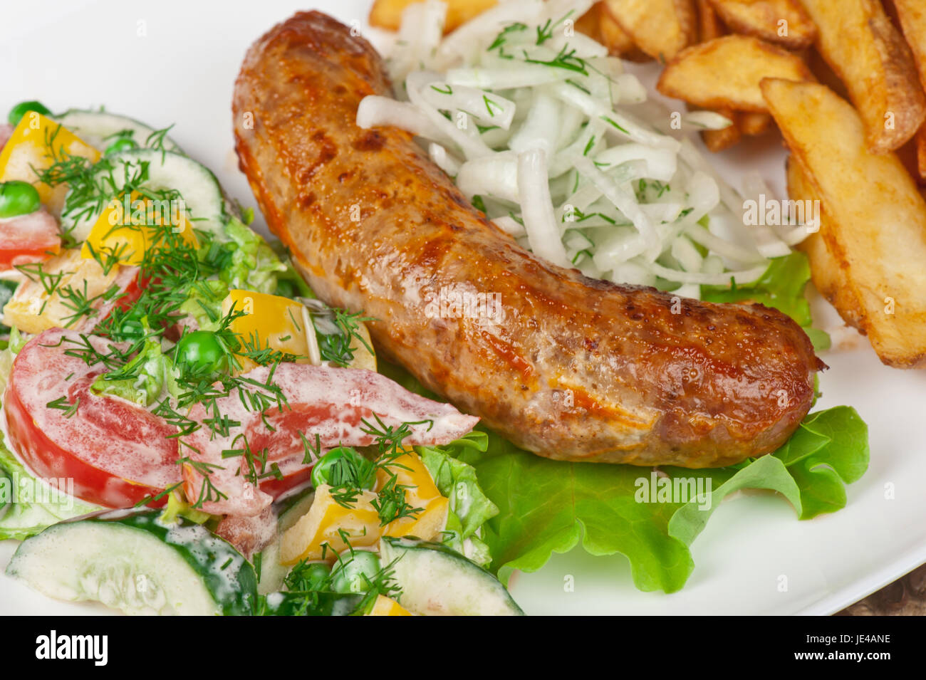 Roasted sausage with vegetables closeup Stock Photo - Alamy
