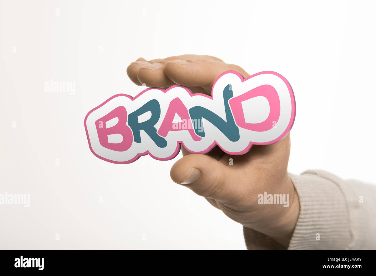One hand holding the word brand over a white background. Company ...