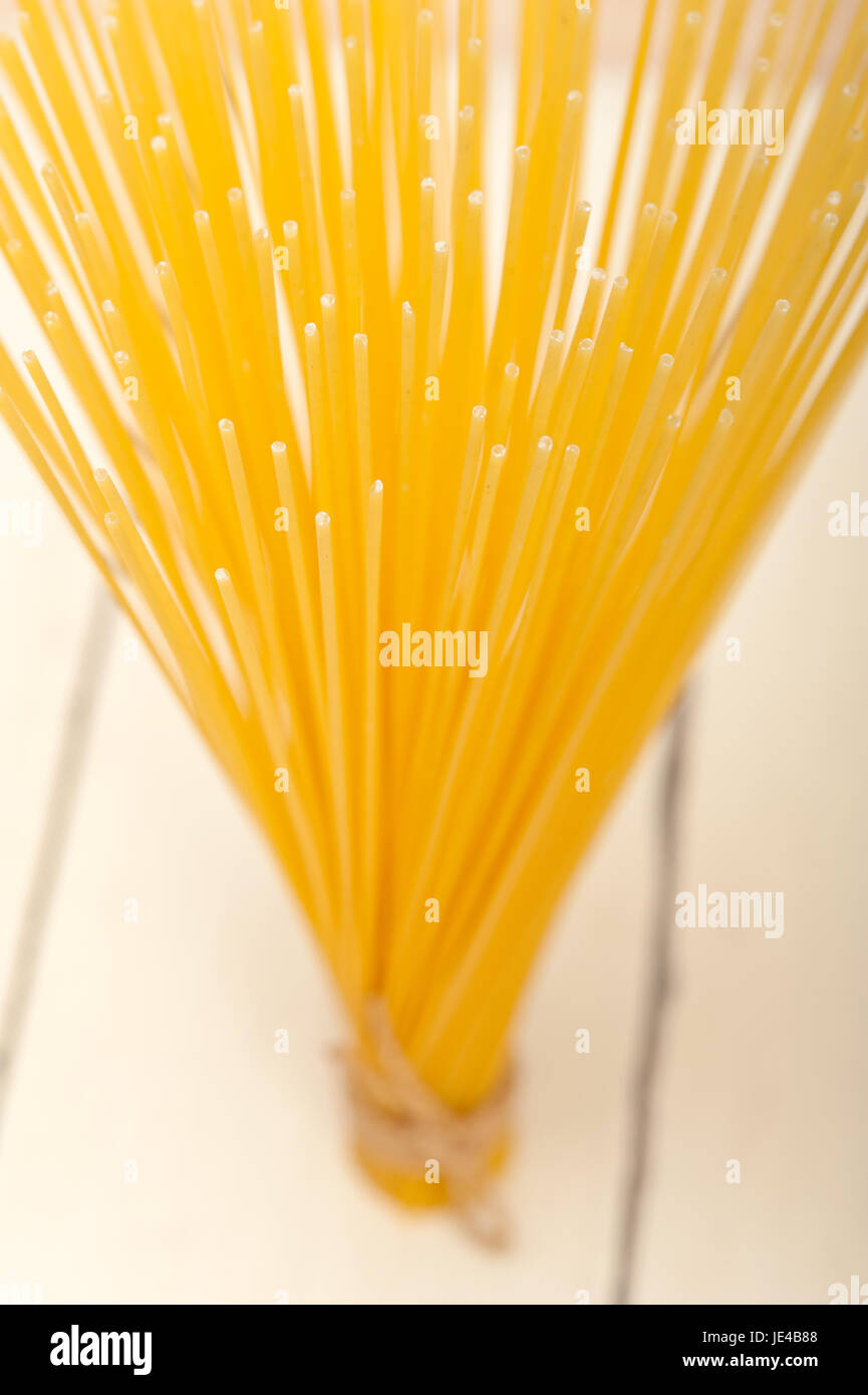 Italian pasta spaghetti tied with a rope on a rustic table Stock Photo ...