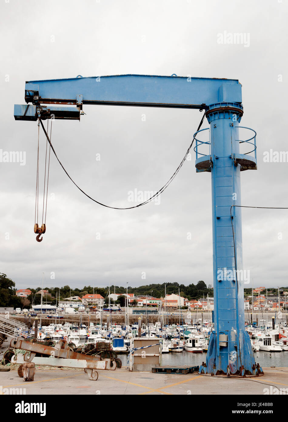 Huge cranes to load boats in a small fishing port Stock Photo - Alamy