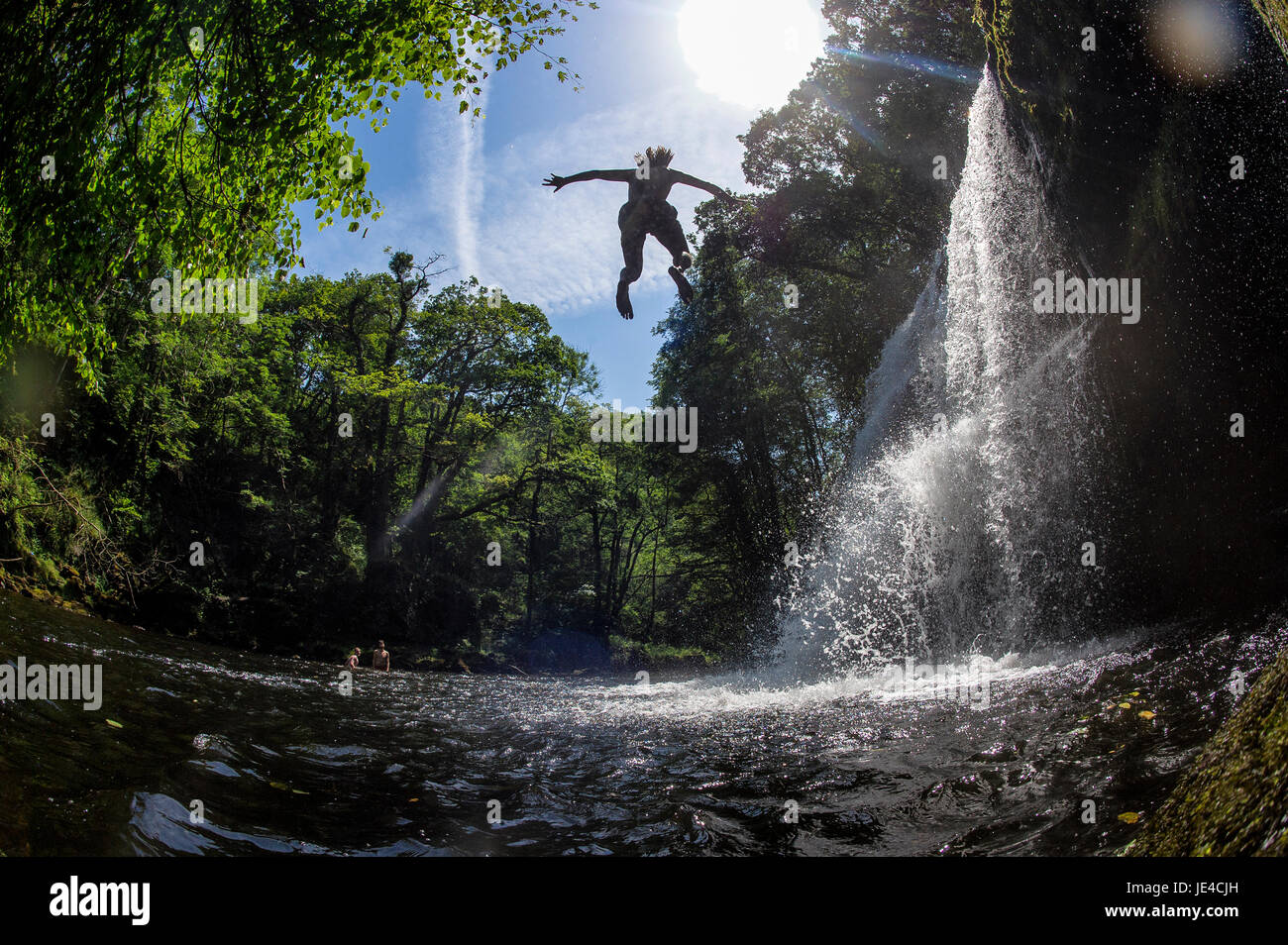 A man jumps in to the water at the Sgwd Y Pannwr waterfall in the ...
