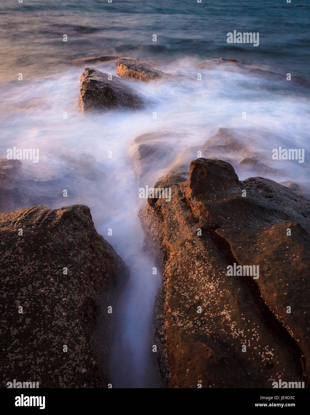 Waves and rocks shore long exposure photo Stock Photo - Alamy
