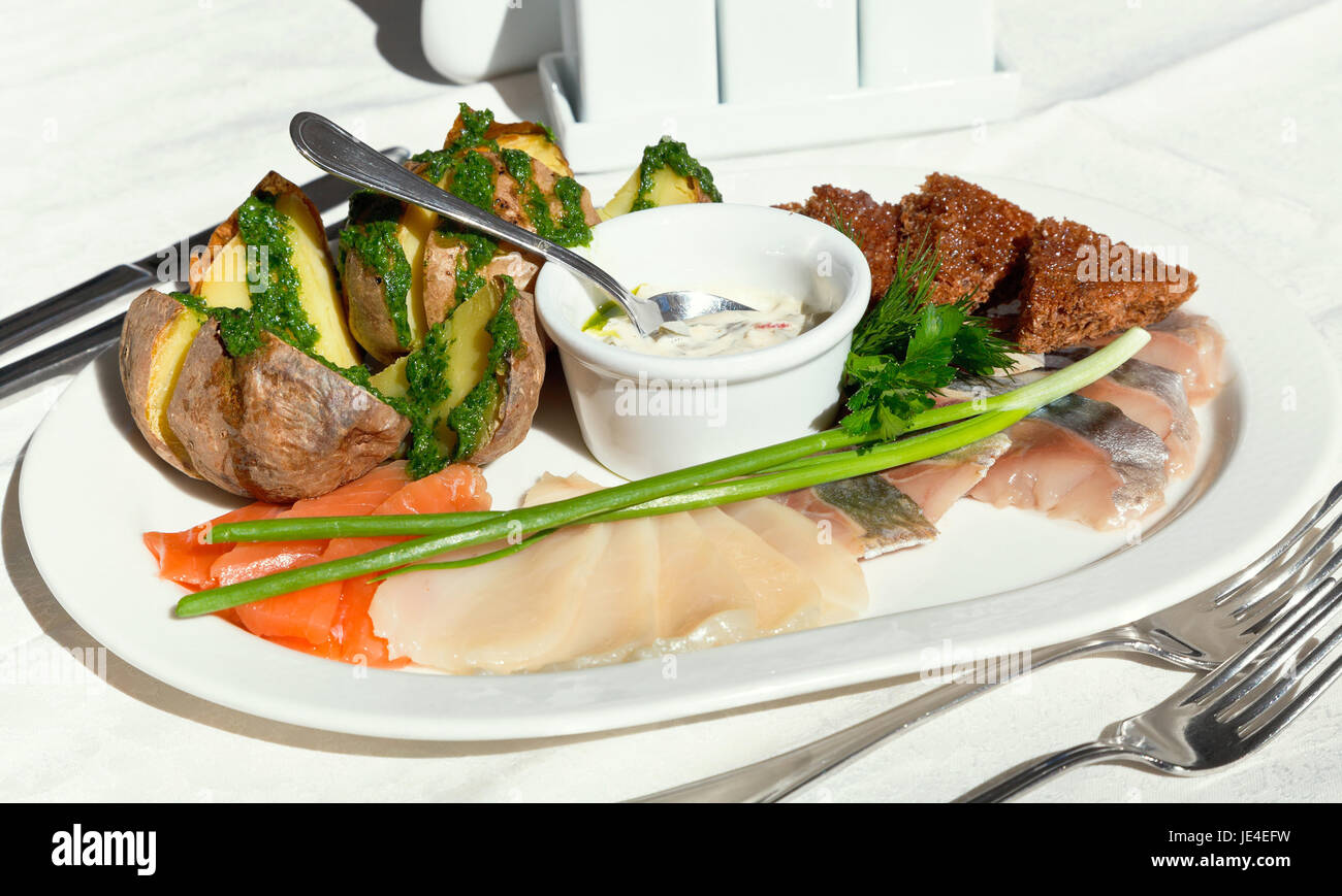 cold appetizer - plate of salted fish with baked potato at outdoor ...