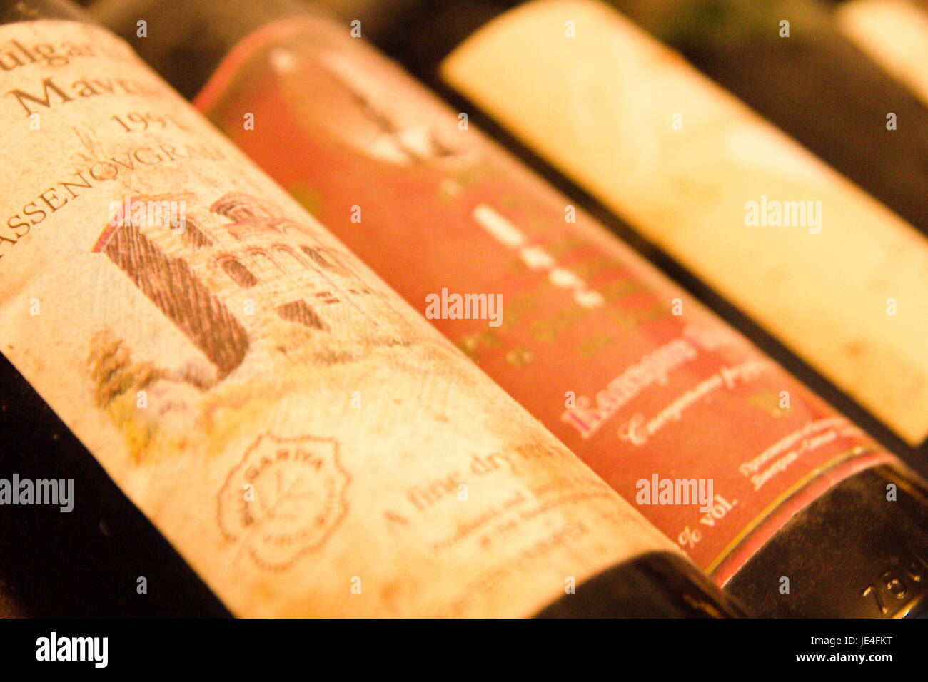 Old bottles of wine in old cellar closeup Stock Photo - Alamy