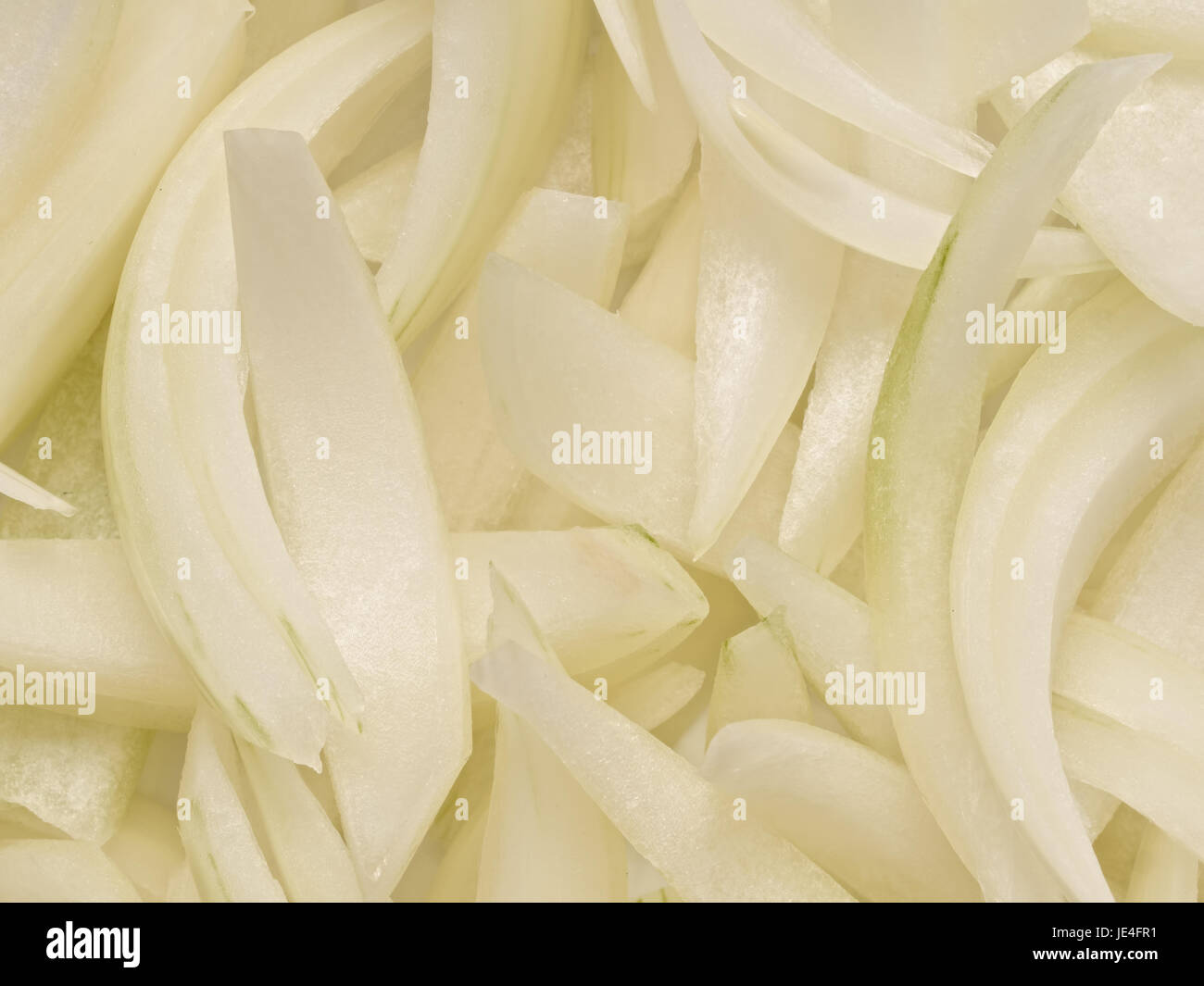 close up of uncooked sliced onion food background Stock Photo - Alamy