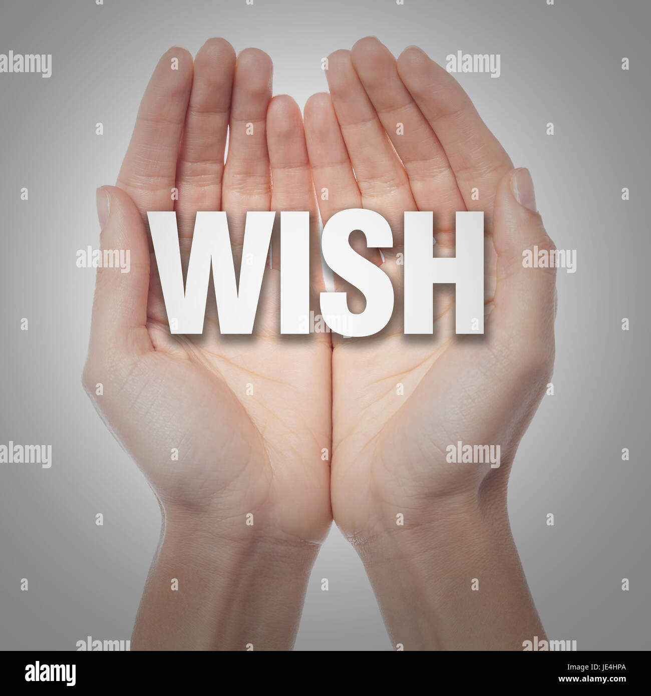 Open hands holding the word wish Stock Photo - Alamy