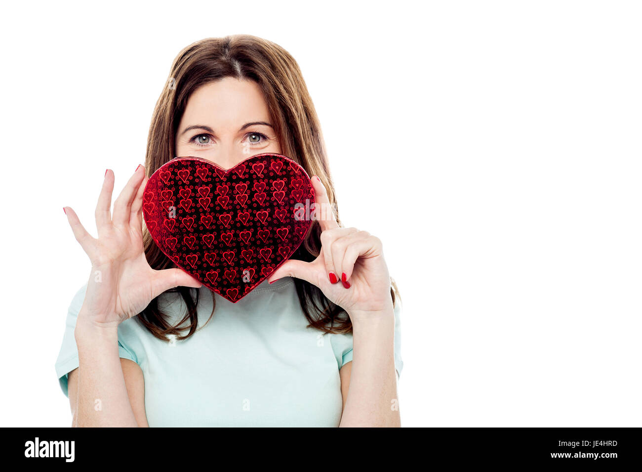 Beautiful woman hiding her face with heart shaped gift box Stock Photo ...