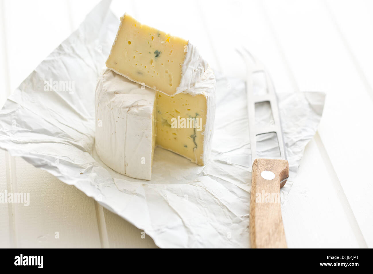 blue cheese on white kitchen table Stock Photo - Alamy