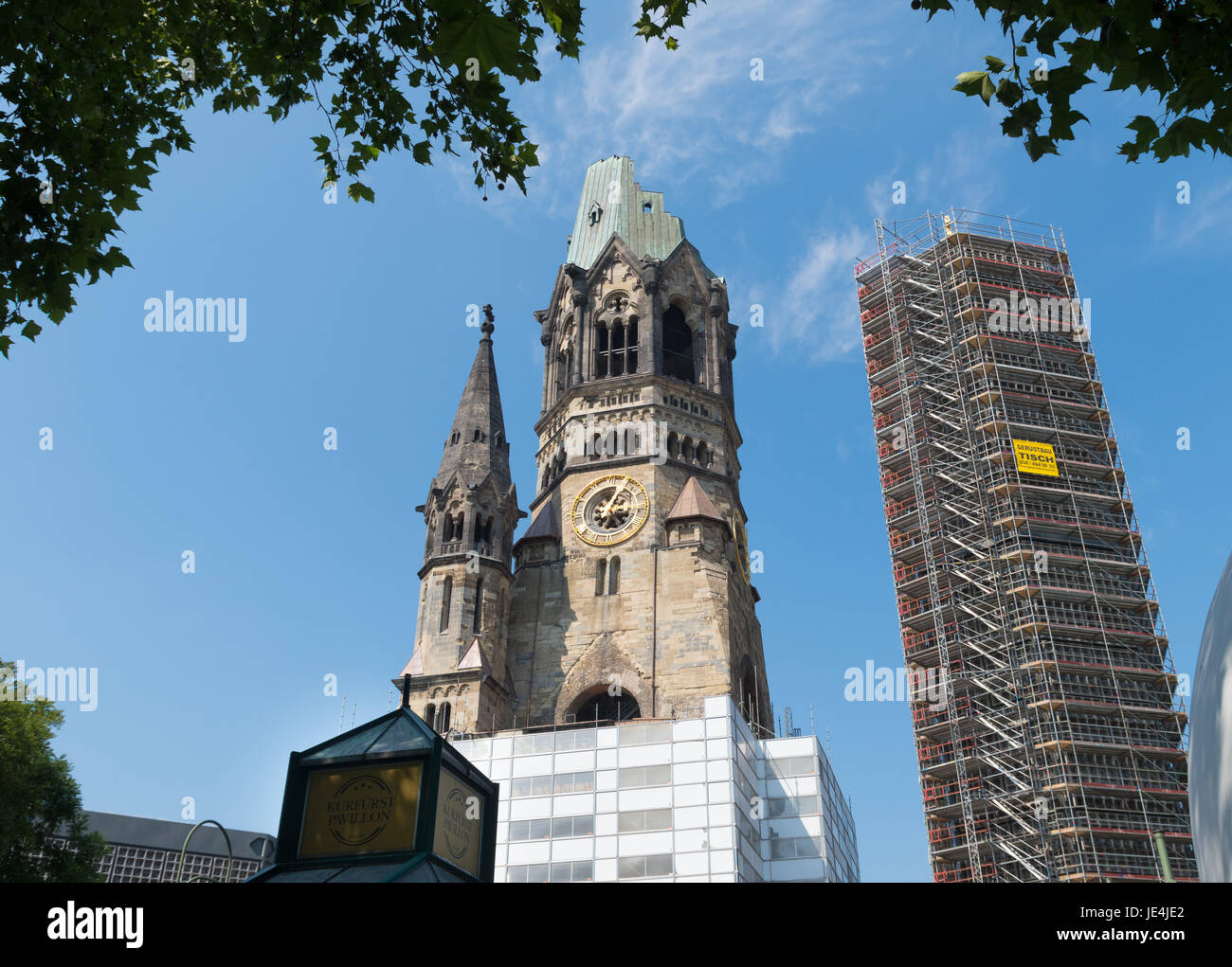 Kaiser Wilhelm Memorial Church next to a modern bell tower in Berlin ...