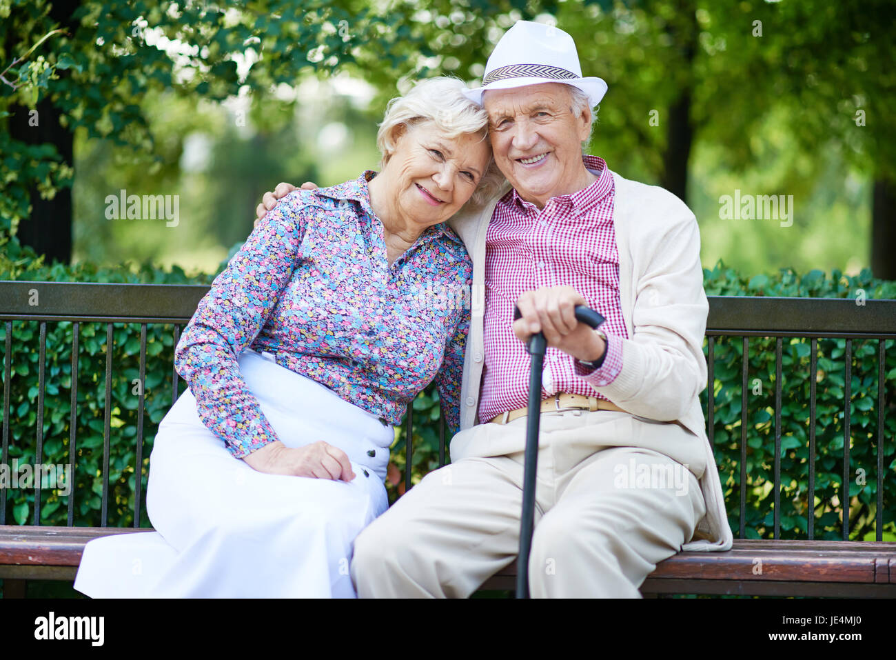 Happy seniors sitting on bench and having rest in the park Stock Photo ...
