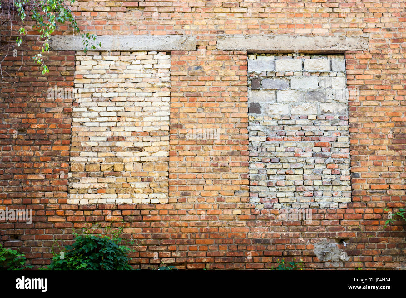 Brick wall with two window openings laid with bricks Stock Photo - Alamy