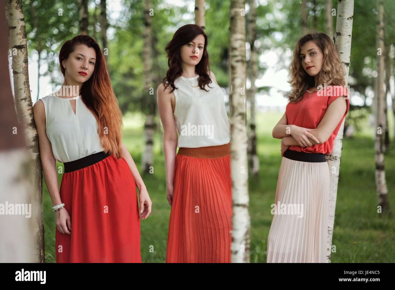 Three standing girls hi-res stock photography and images - Alamy