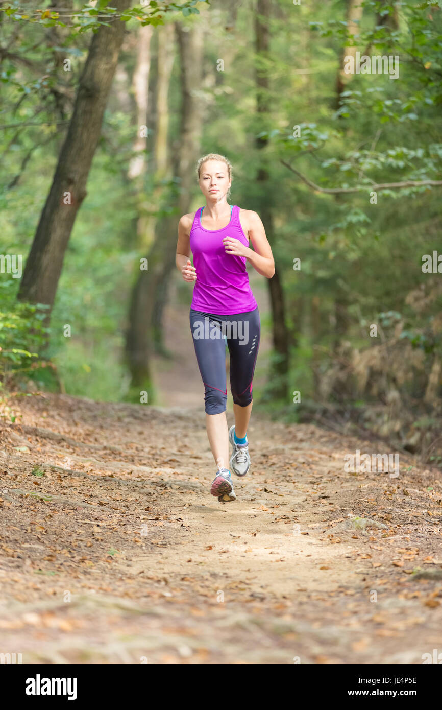 Pretty young girl runner in the forest. Running woman. Female Runner ...